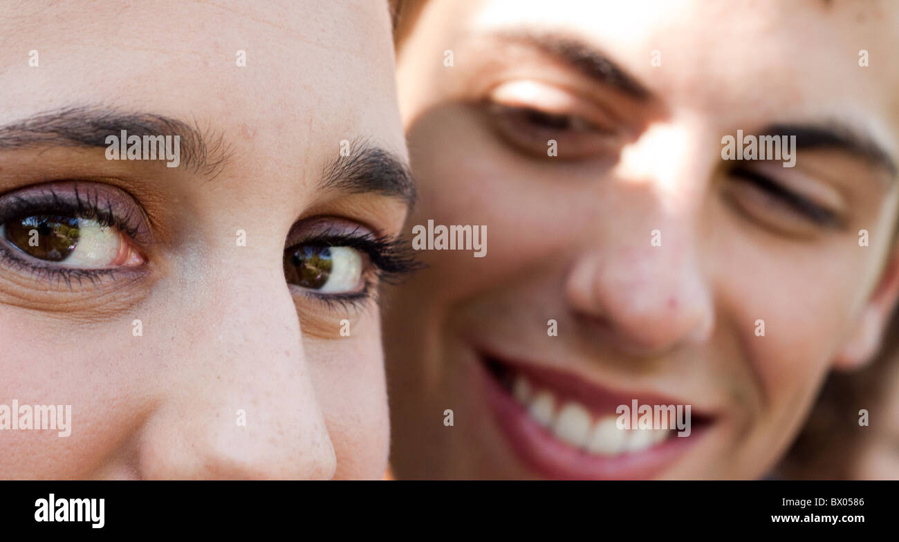 A woman's eyes look left as her husband looks at her from the ...