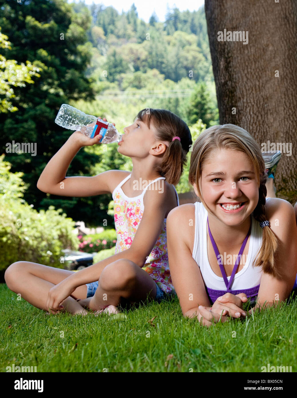 Caucasian girls relaxing in park Stock Photo - Alamy