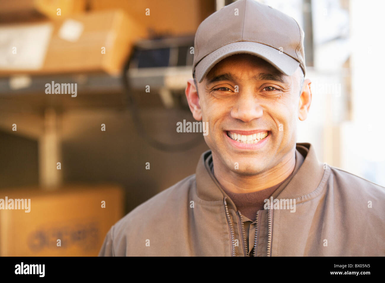 Smiling Hispanic delivery man Stock Photo - Alamy