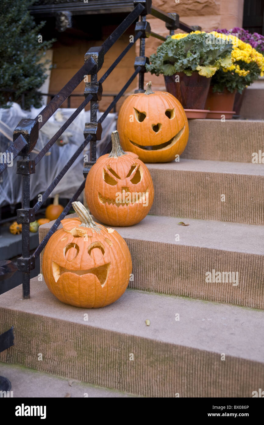 Halloween pumpkins to greet trick-or-treaters on the steps of a ...