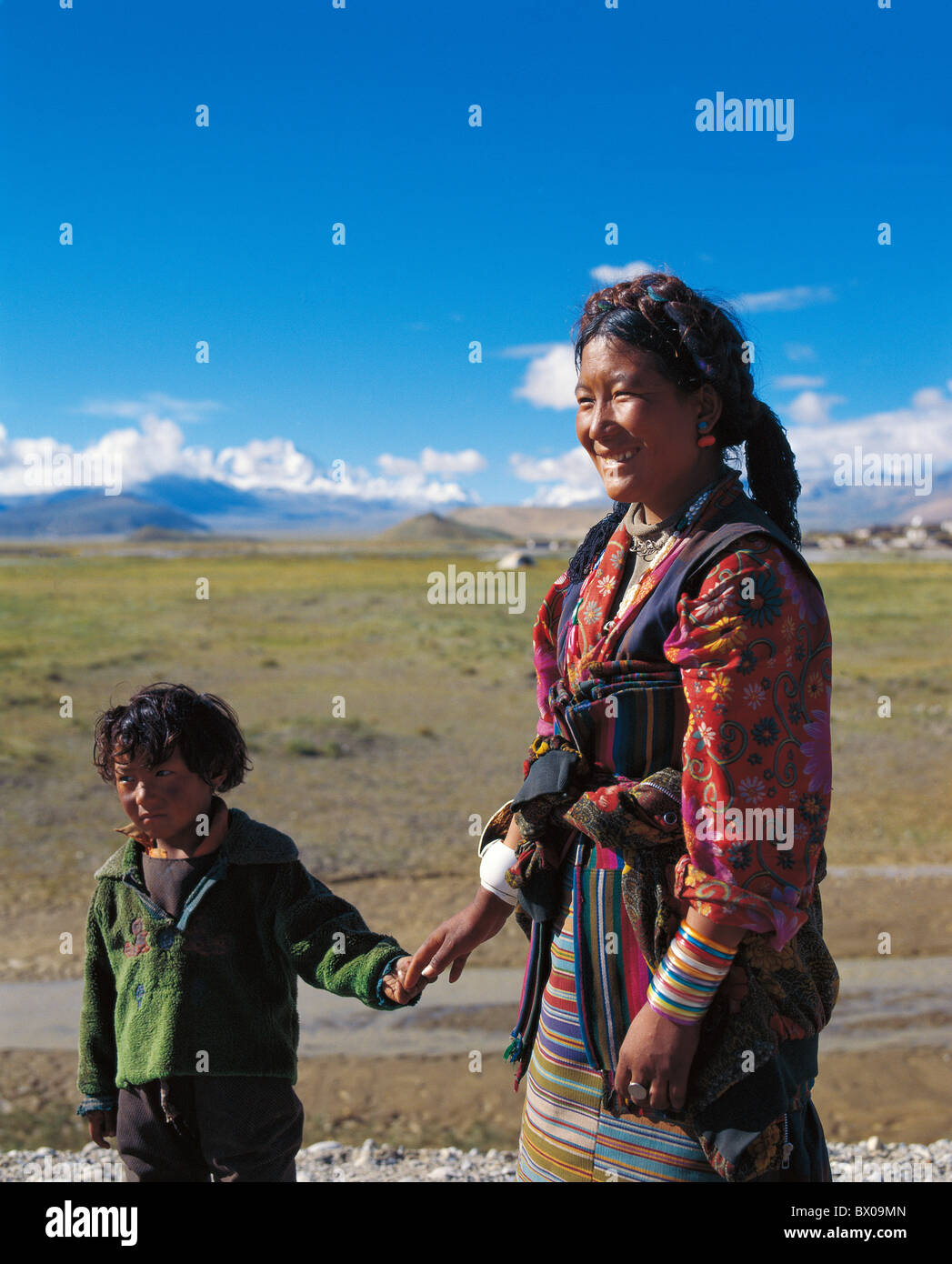 Tibetan woman in traditional costume with her son, Tingri, Xigaze ...