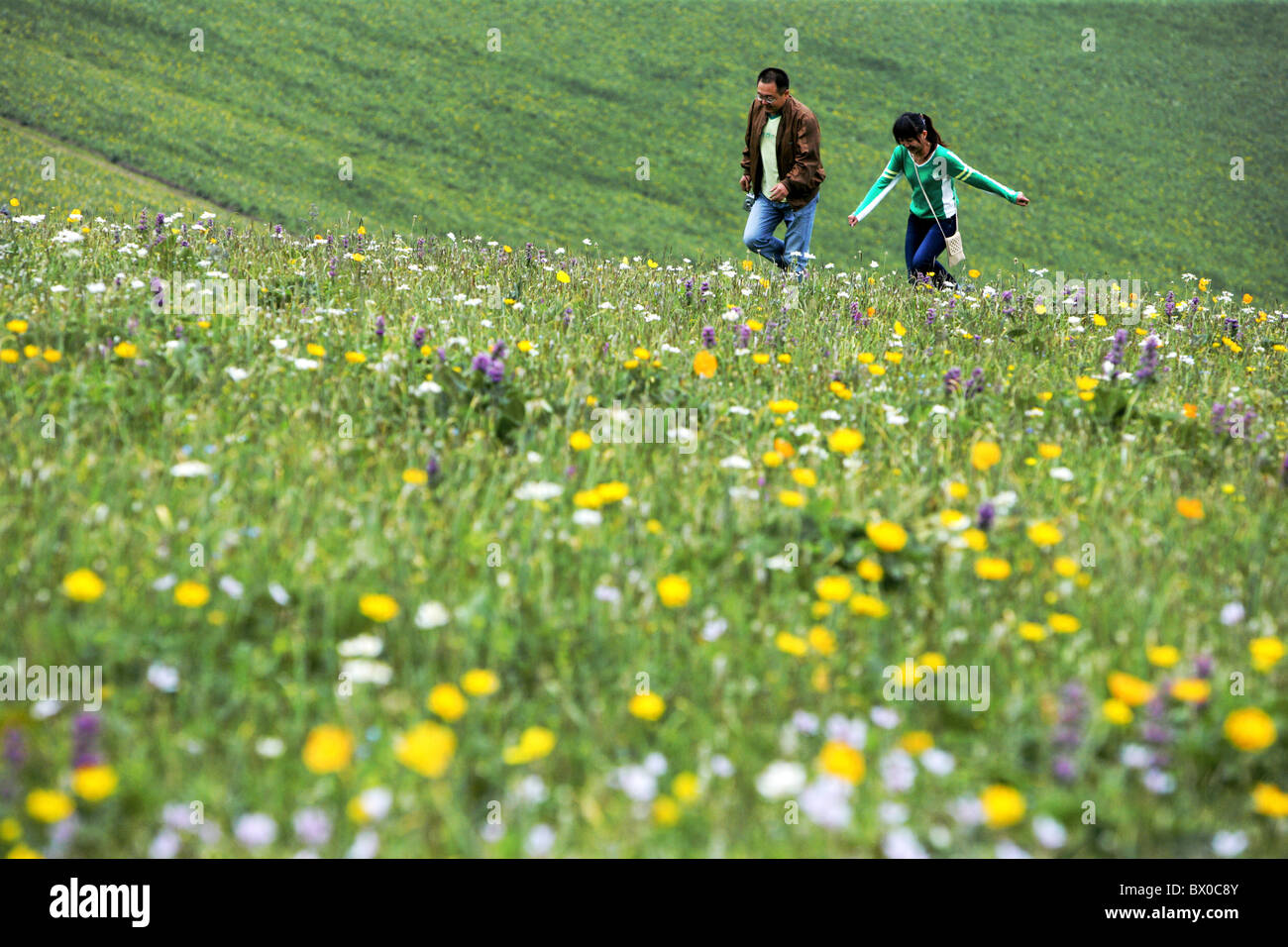 Chinese couple enjoying green pasture of Nalat Grassland, Ili Kazakh ...