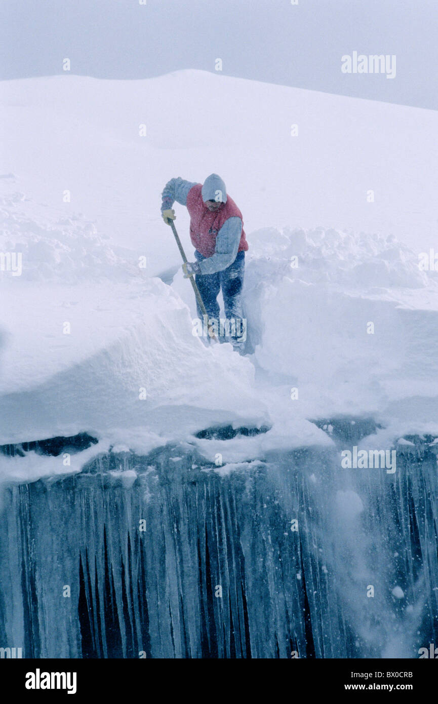 roof icicle man brook Muhl Austria Europe Salzburg shovel snow snow ...