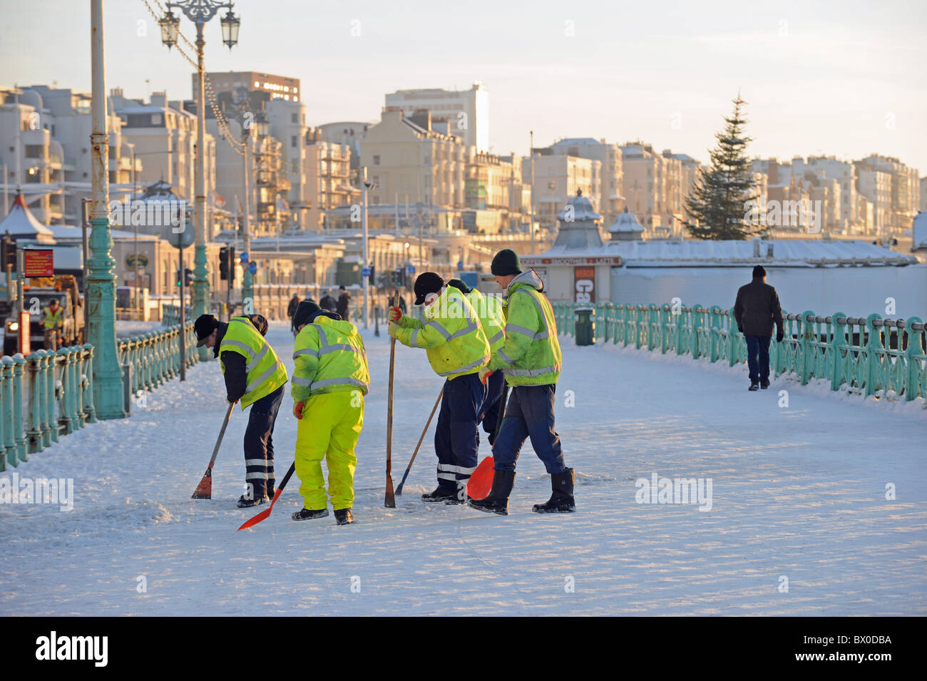 Council workers clearing snow from the promenade on Brighton seafront ...