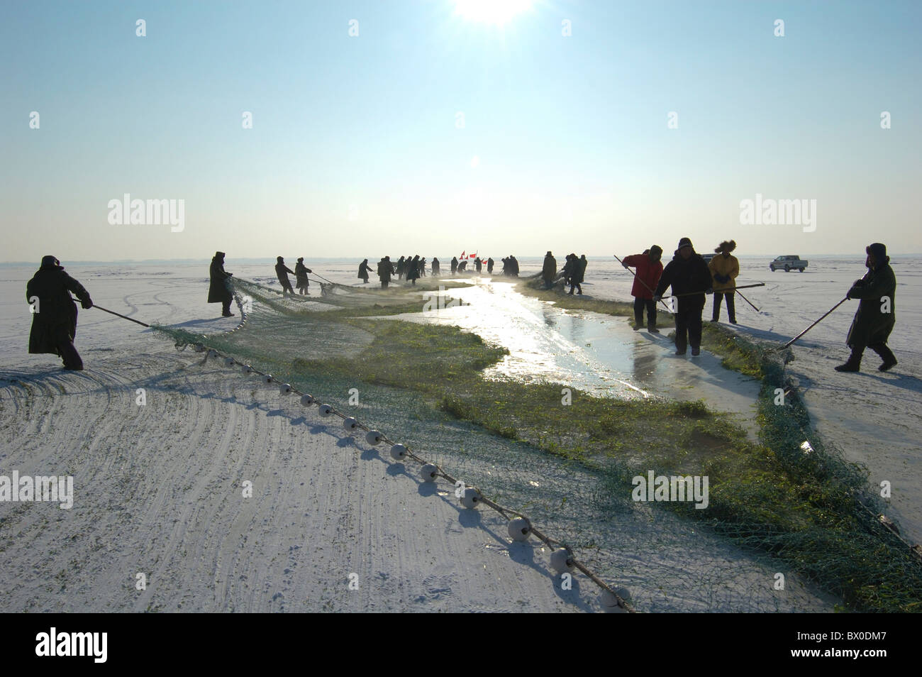 Fishermen unfolding fish net during Winter Fishing, Dorbod Mongol ...