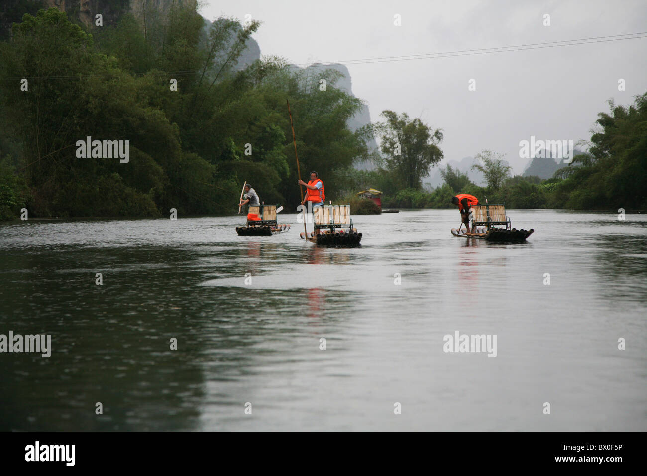 Chinese men driving raft, Yulong River, Guilin, Guangxi Province, China ...
