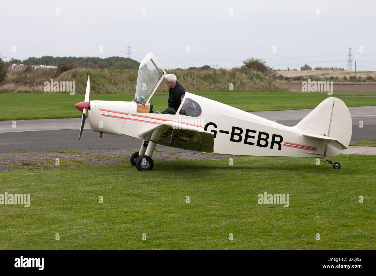SIPA Minicab GY-201 (Modified) G-BEBR parked on the grass with pilot ...