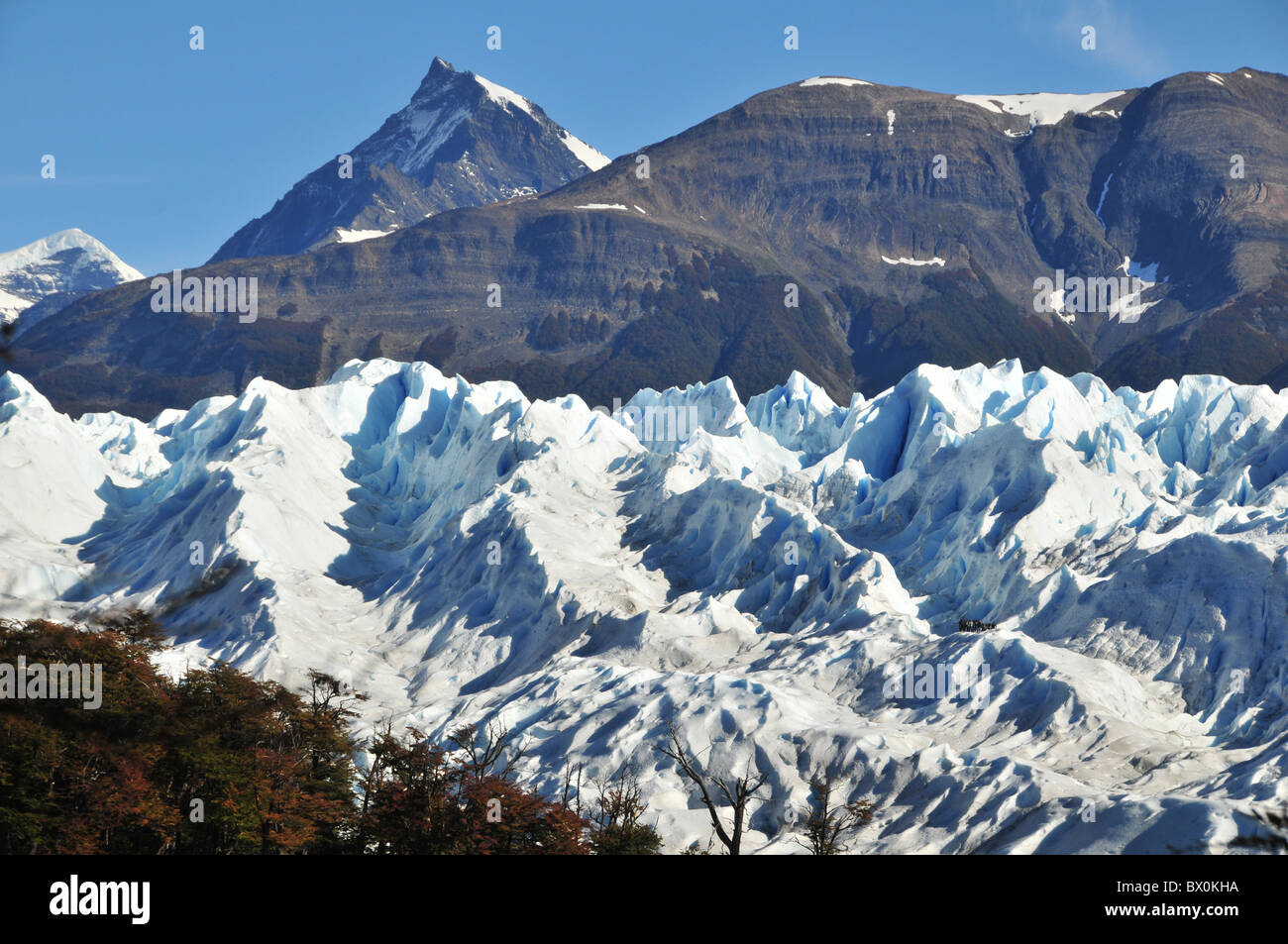 Andean view of a group of ice-trekkers on the gullied surface of the ...