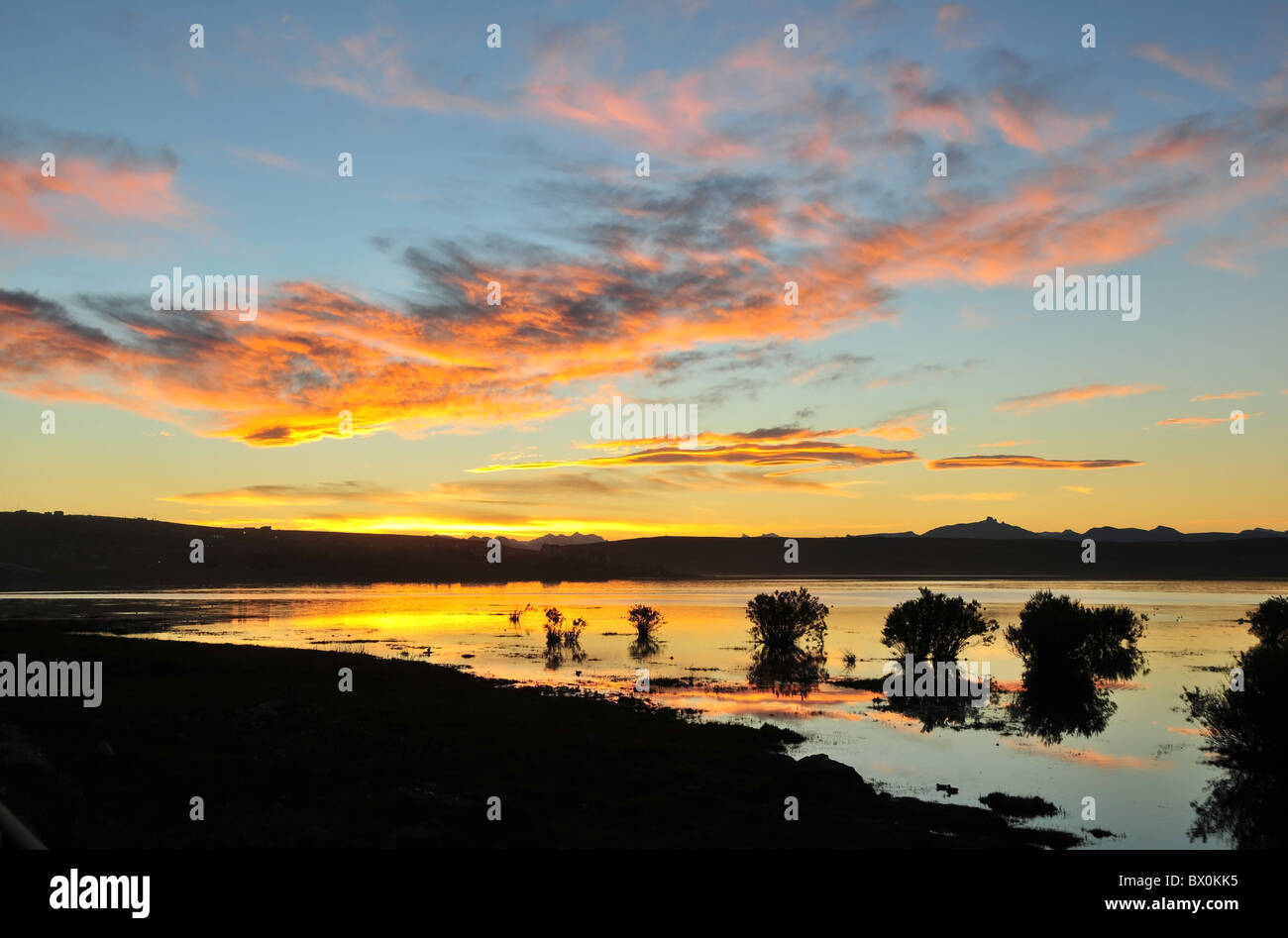 Blue sky orange clouds sunset reflection in the waters of Bahia Redonda ...