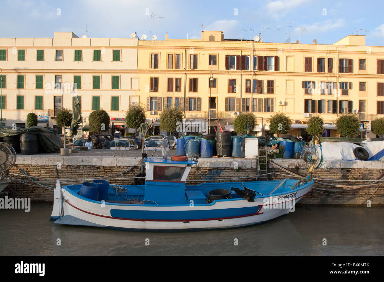 old aged fishing boat moored in canal of Tiber river in Fiumicino Rome ...