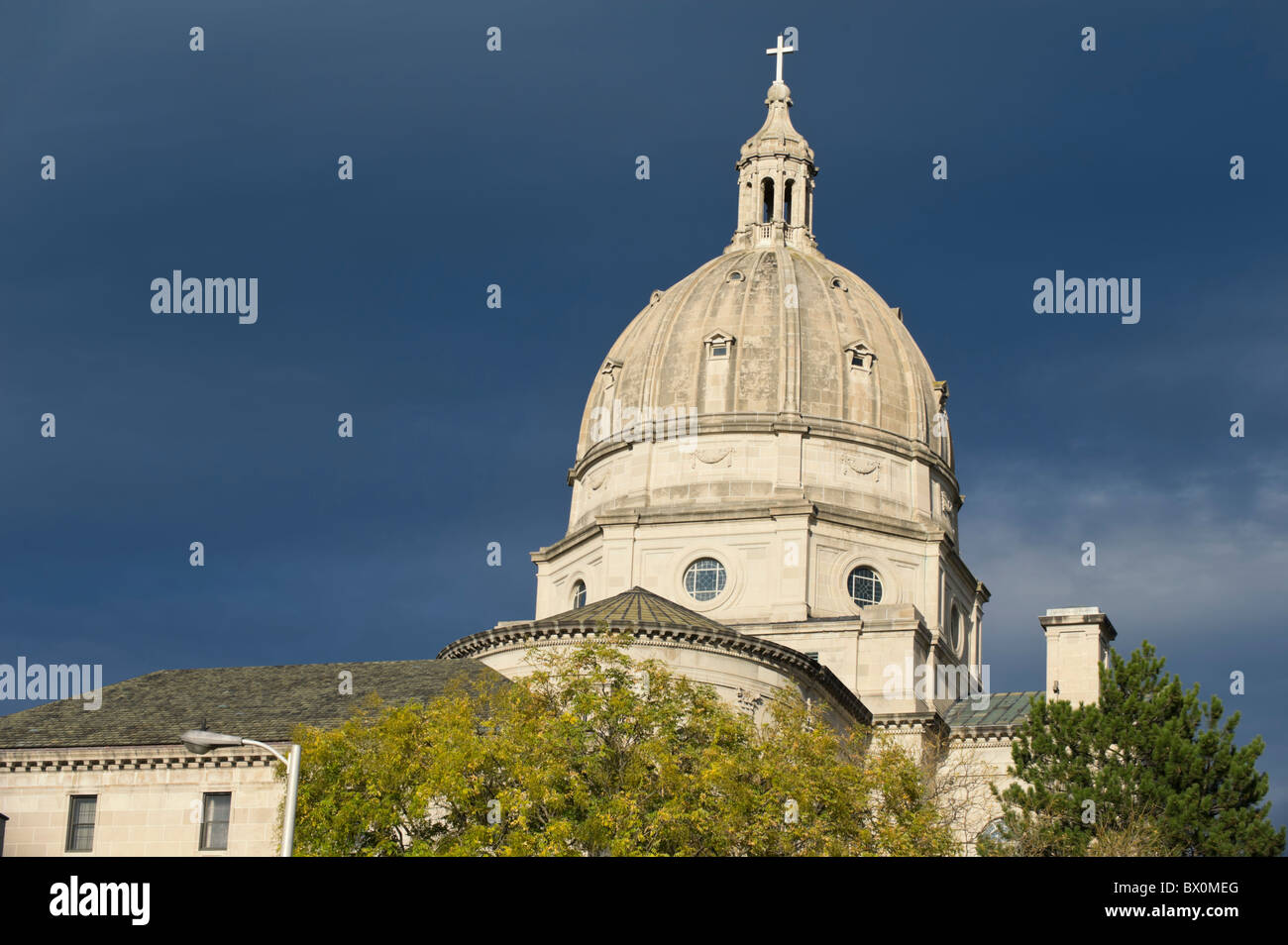 Catholic cathedral dome in last light of day with dark of night coming ...