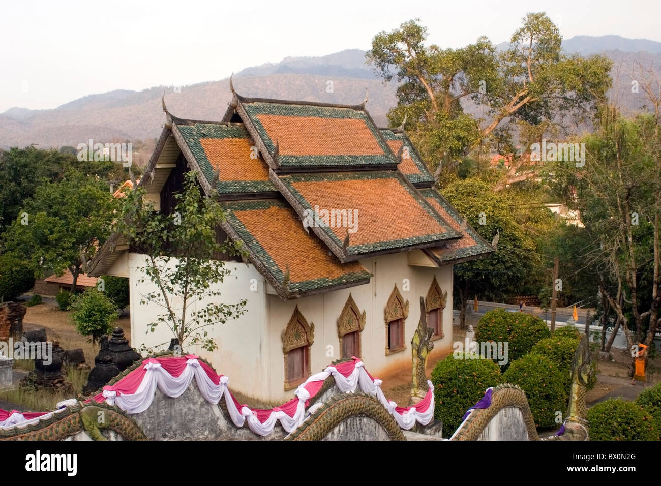 A beautiful old Buddhist temple is part of the city landscape in the ...