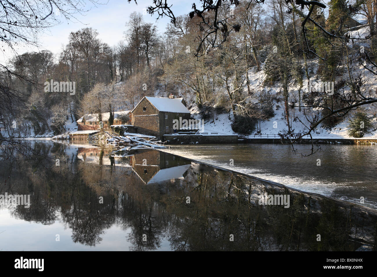 The mill house and weir seen reflected in the river Wear, Durham City ...