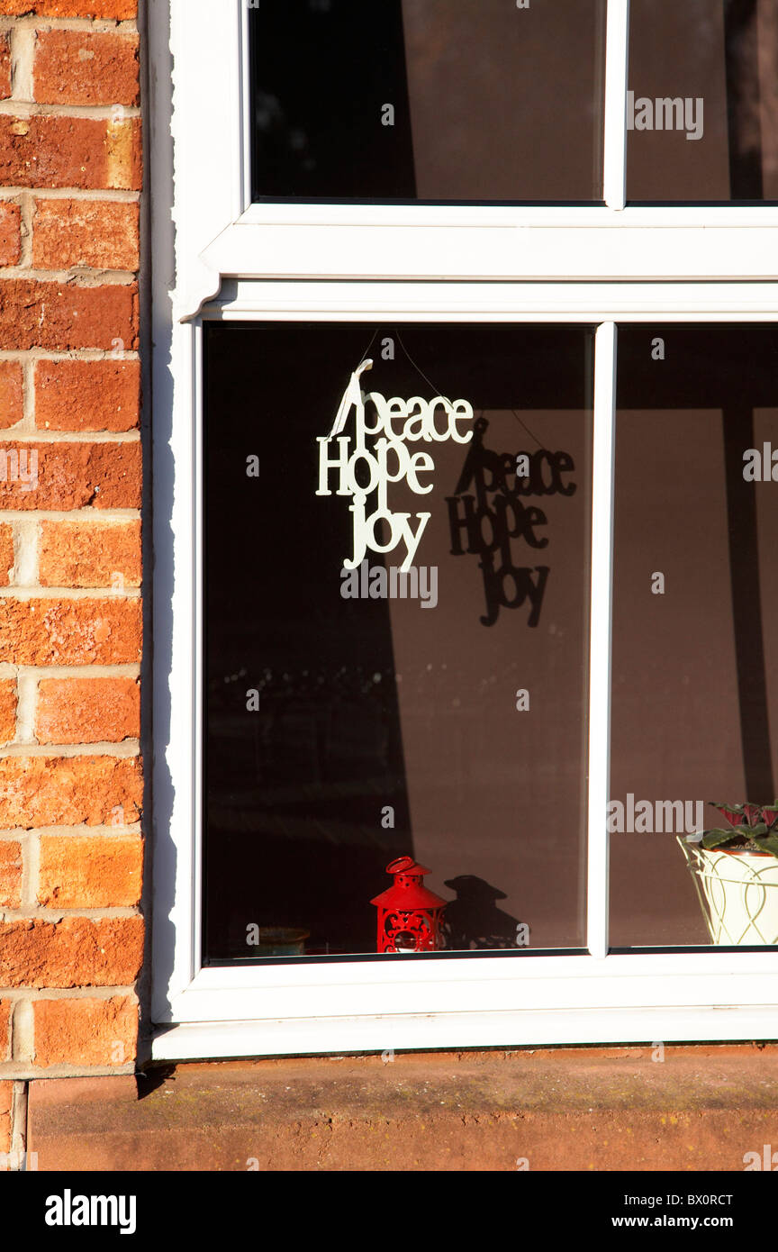 Peace Hope Joy decoration with shadow play in window Stock Photo - Alamy