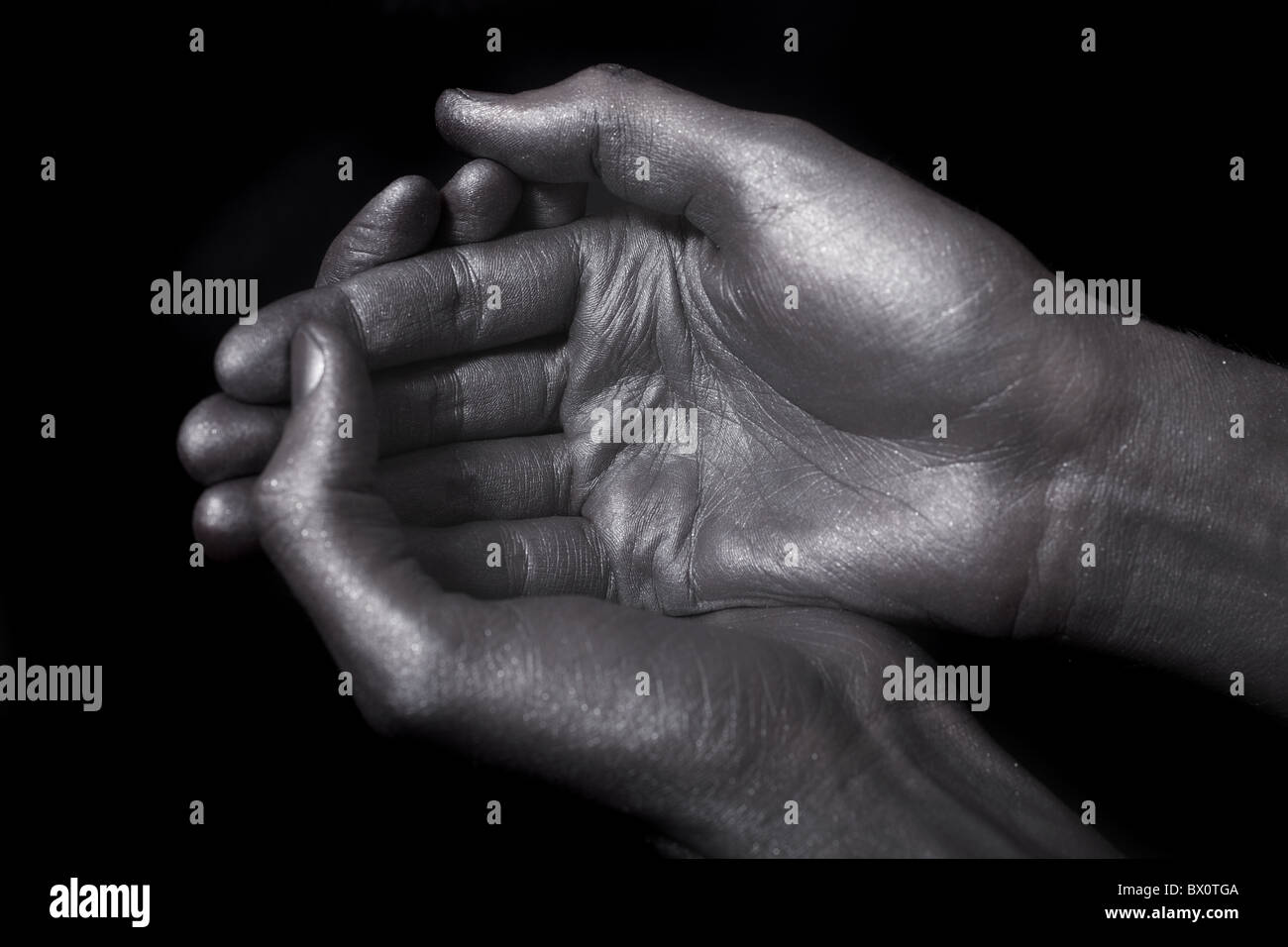beautiful male hands in silver paint on black background Stock Photo ...