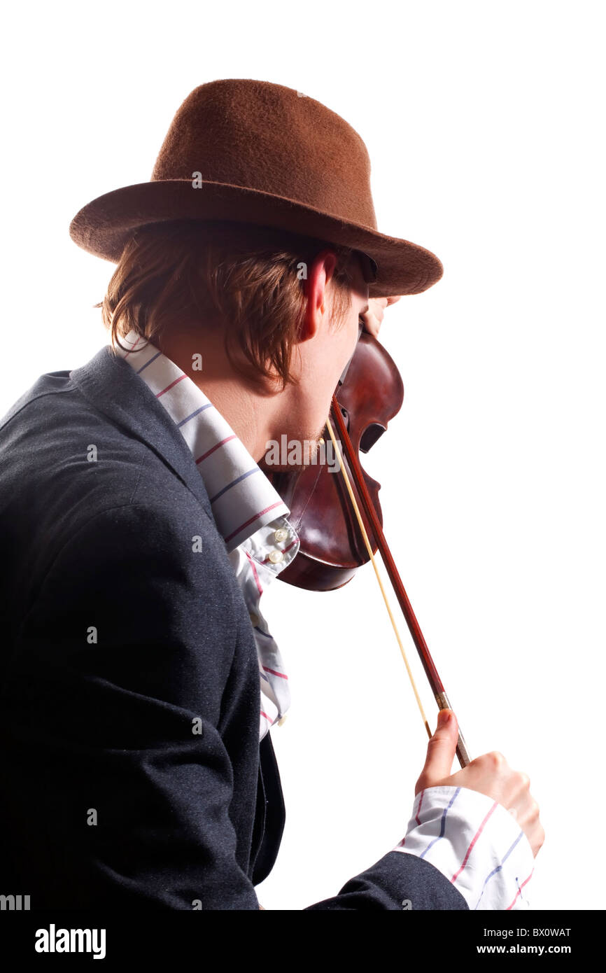 back of violinist playing the violin in hat and jacket on white ...