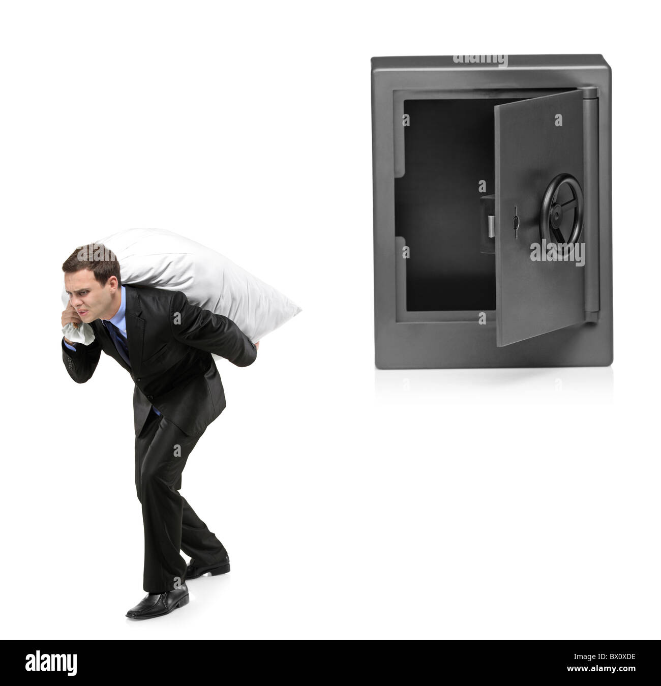 Full length portrait of a man stealing a money bag from a deposit safe ...