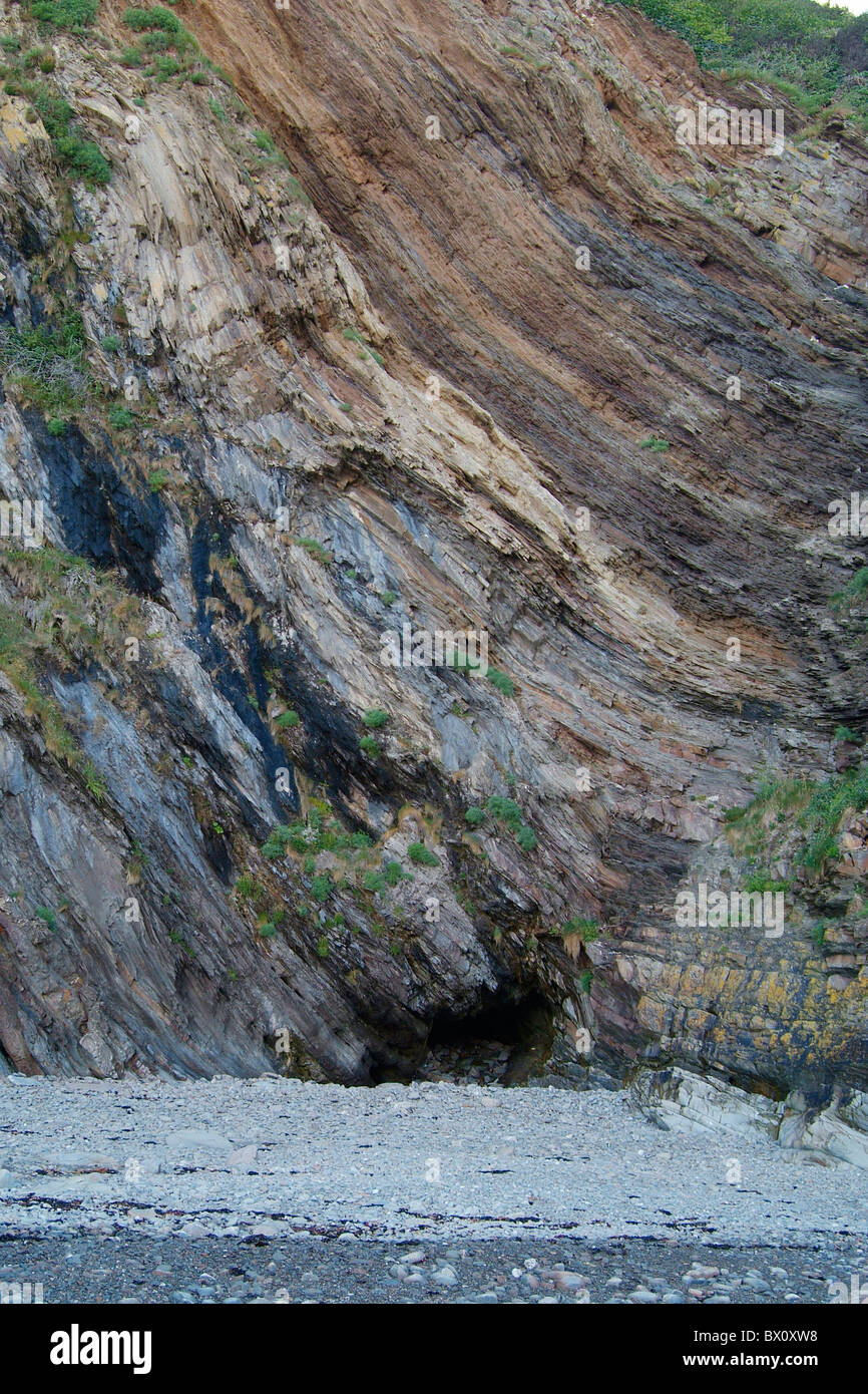 coloured rock strata patterns and cave at Combe Martin Stock Photo - Alamy