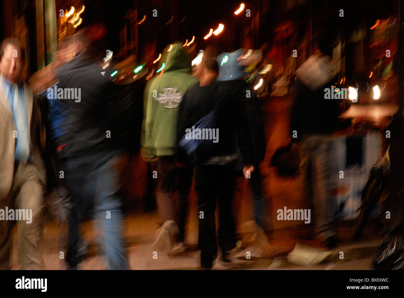 Urban gang of youth in city streets at night Stock Photo - Alamy