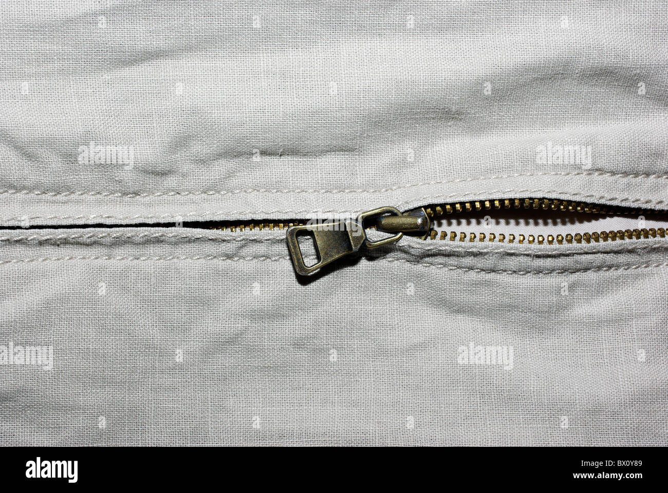 Abstract beige textured textile with zipper in center horizontal ...