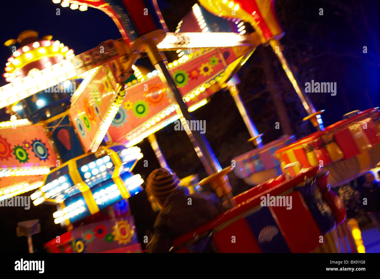 kids on fairground ride at dusk Stock Photo - Alamy