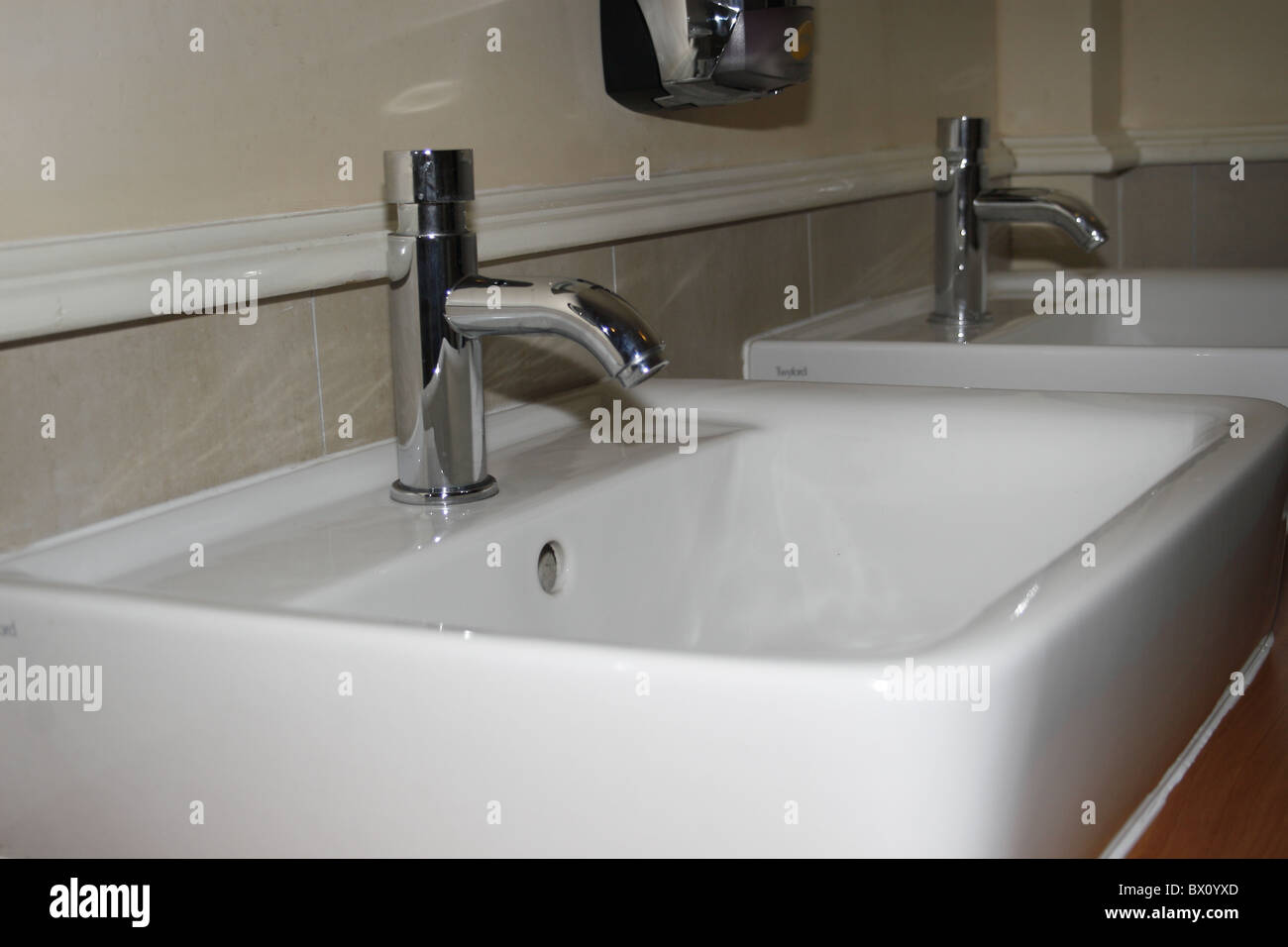 sinks in gents toilet Stock Photo - Alamy