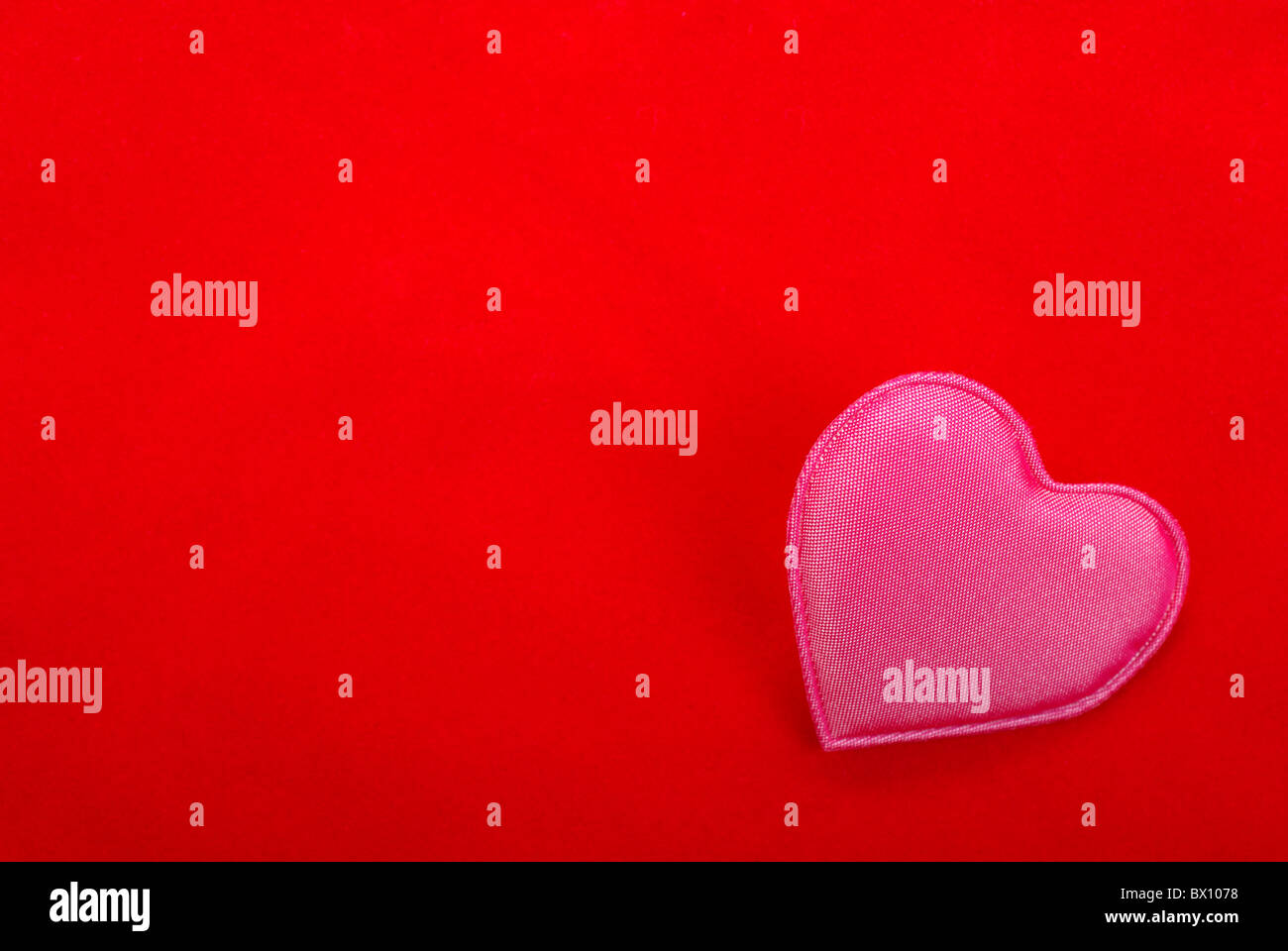Pink heart isolated on red background. Empty space for your desgin ...