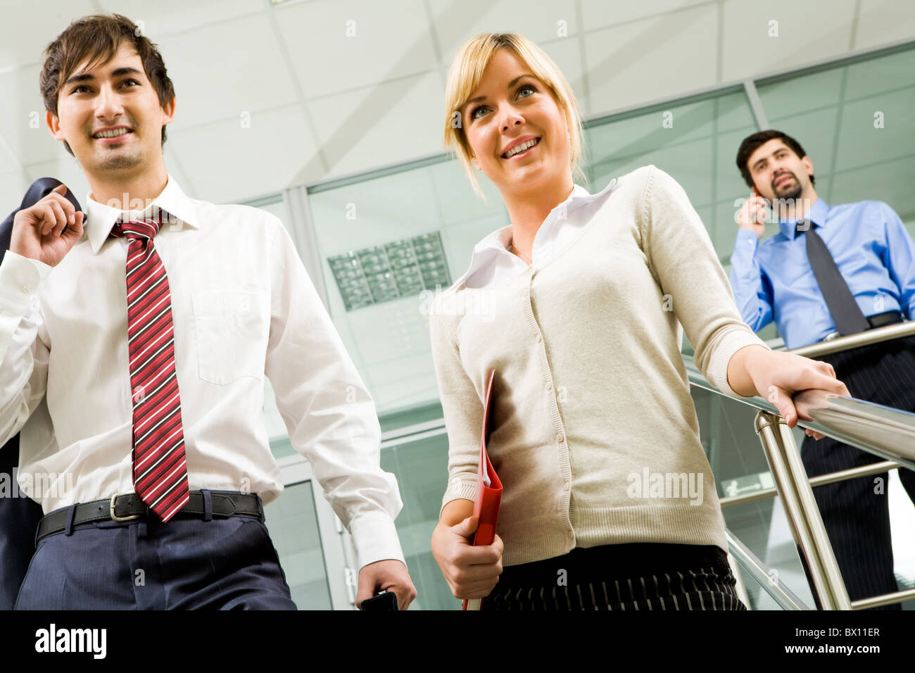 Photo of successful business partners in office building Stock Photo ...