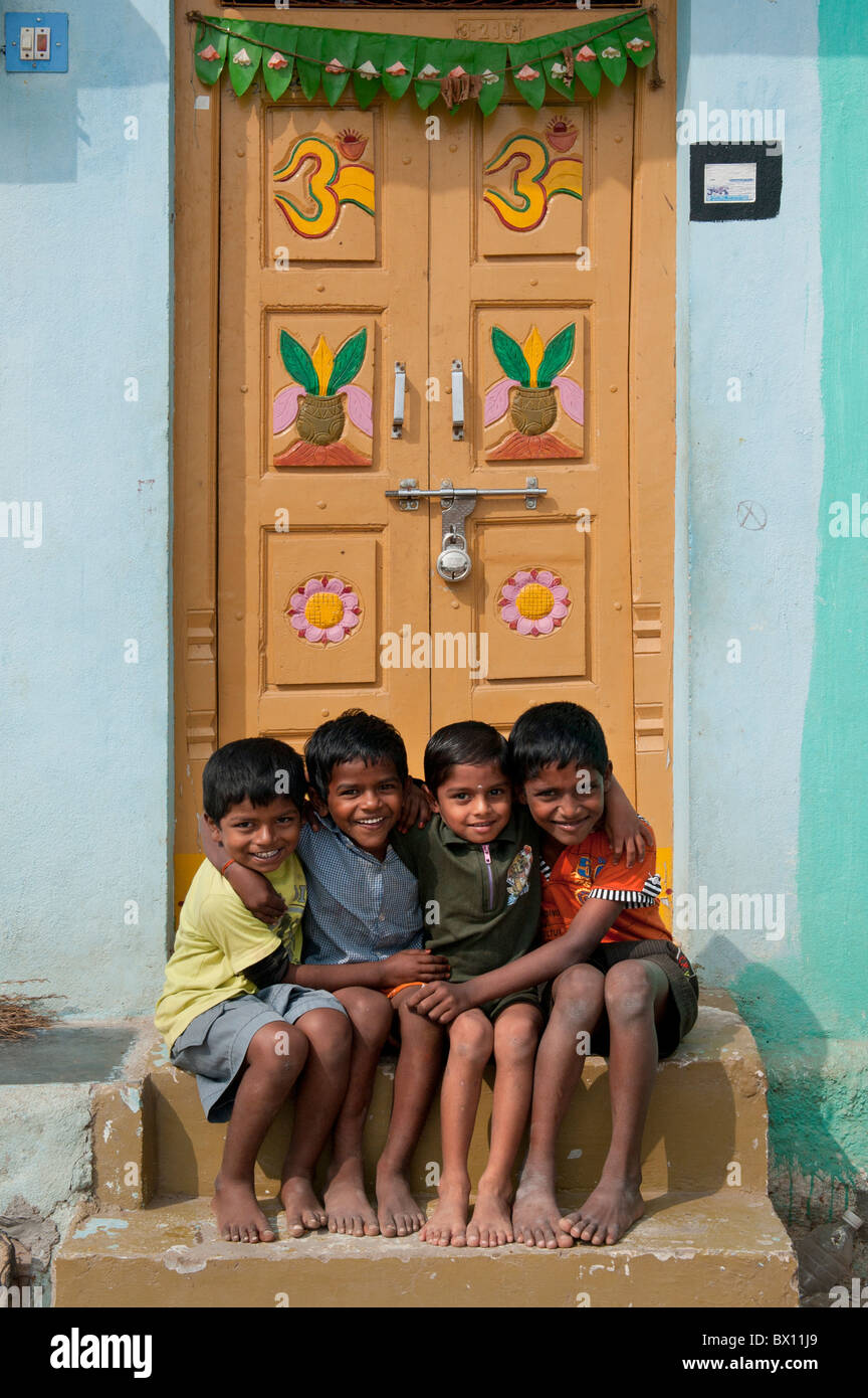 Indian village boys sat outside a house in Kothacheruvu, Andhra Pradesh ...