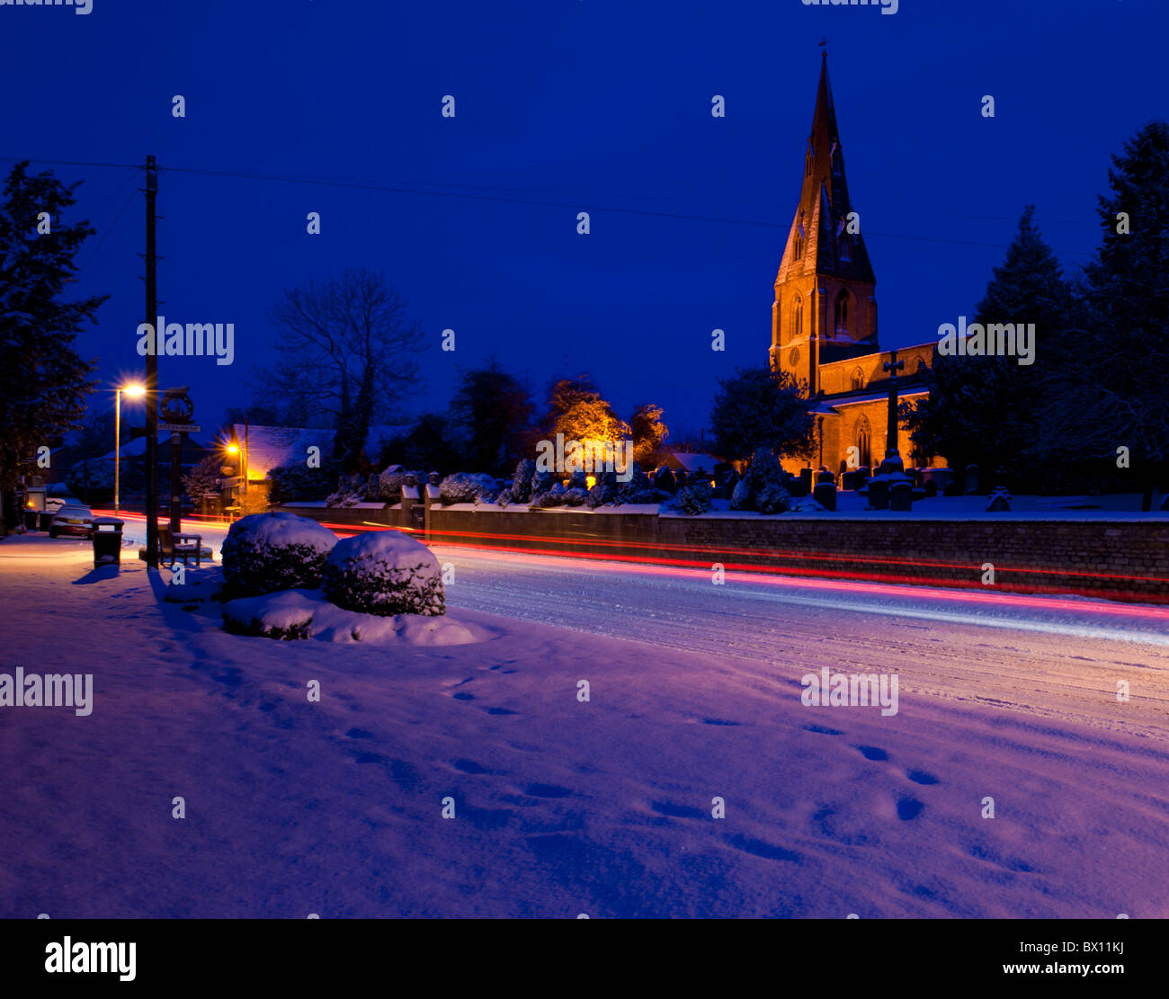Rutland, England. Passing cars leave light trails in the village of ...