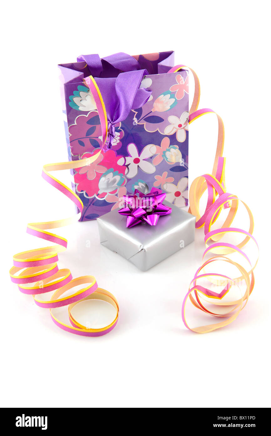 bag with gift and party streamer over white background Stock Photo - Alamy