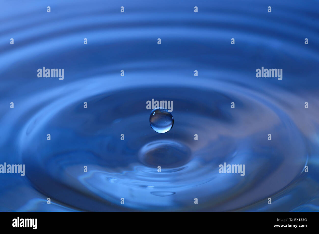 A water drop in the form of a pearl and splash Stock Photo - Alamy