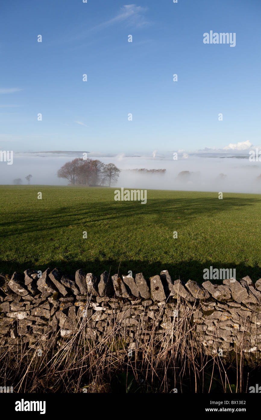 A temperature inversion above the Wye valley in Derbyshire. Smoke ...