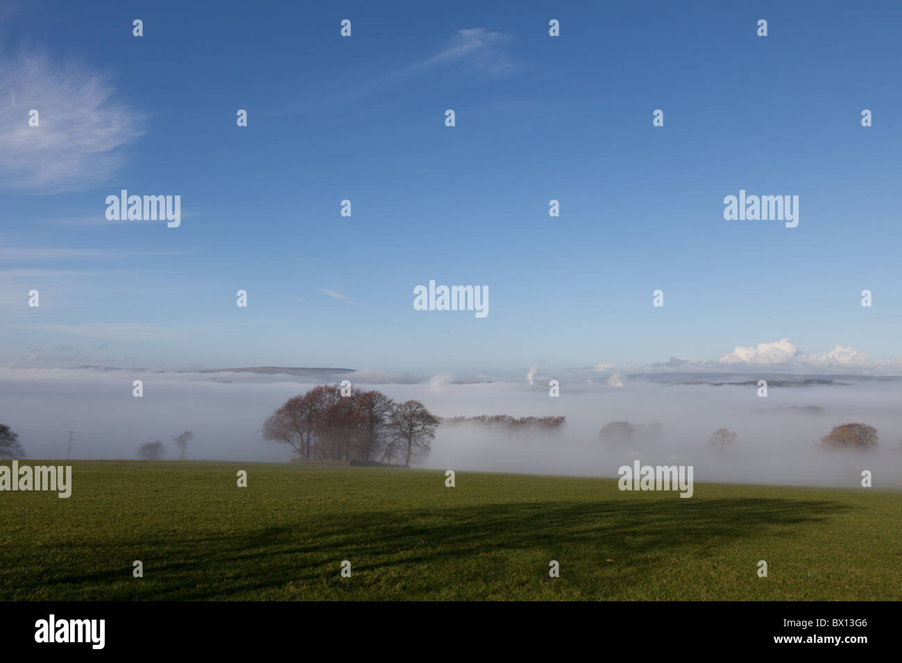 A temperature inversion above the Wye valley in Derbyshire. Smoke ...