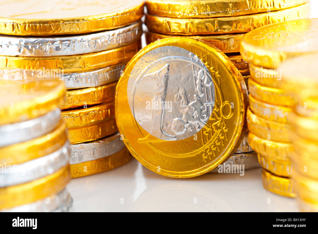pile of chocolate euro money in closeup over white background Stock ...