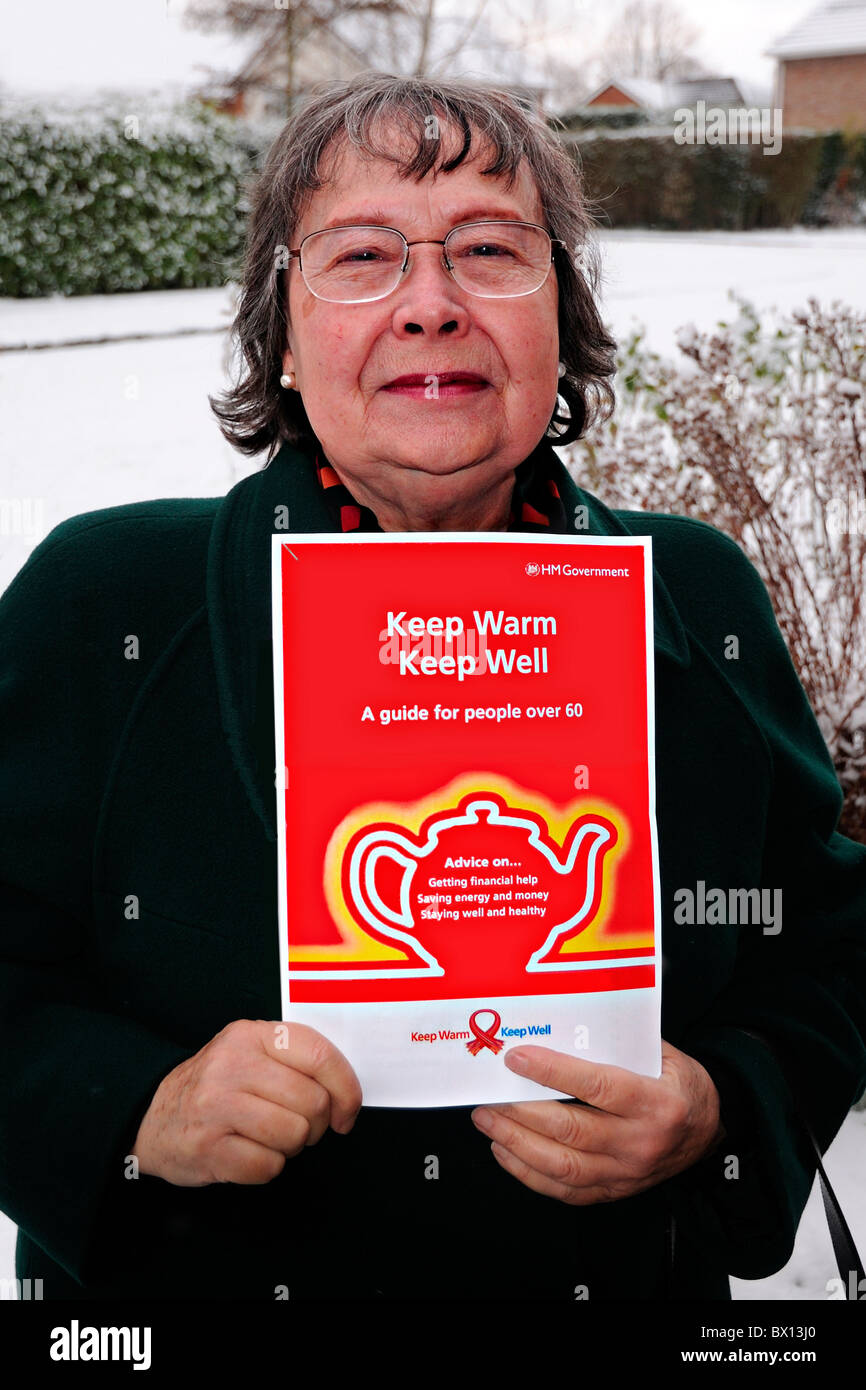 74 year old woman lady pensioner holding HM Government leaflet KEEP ...
