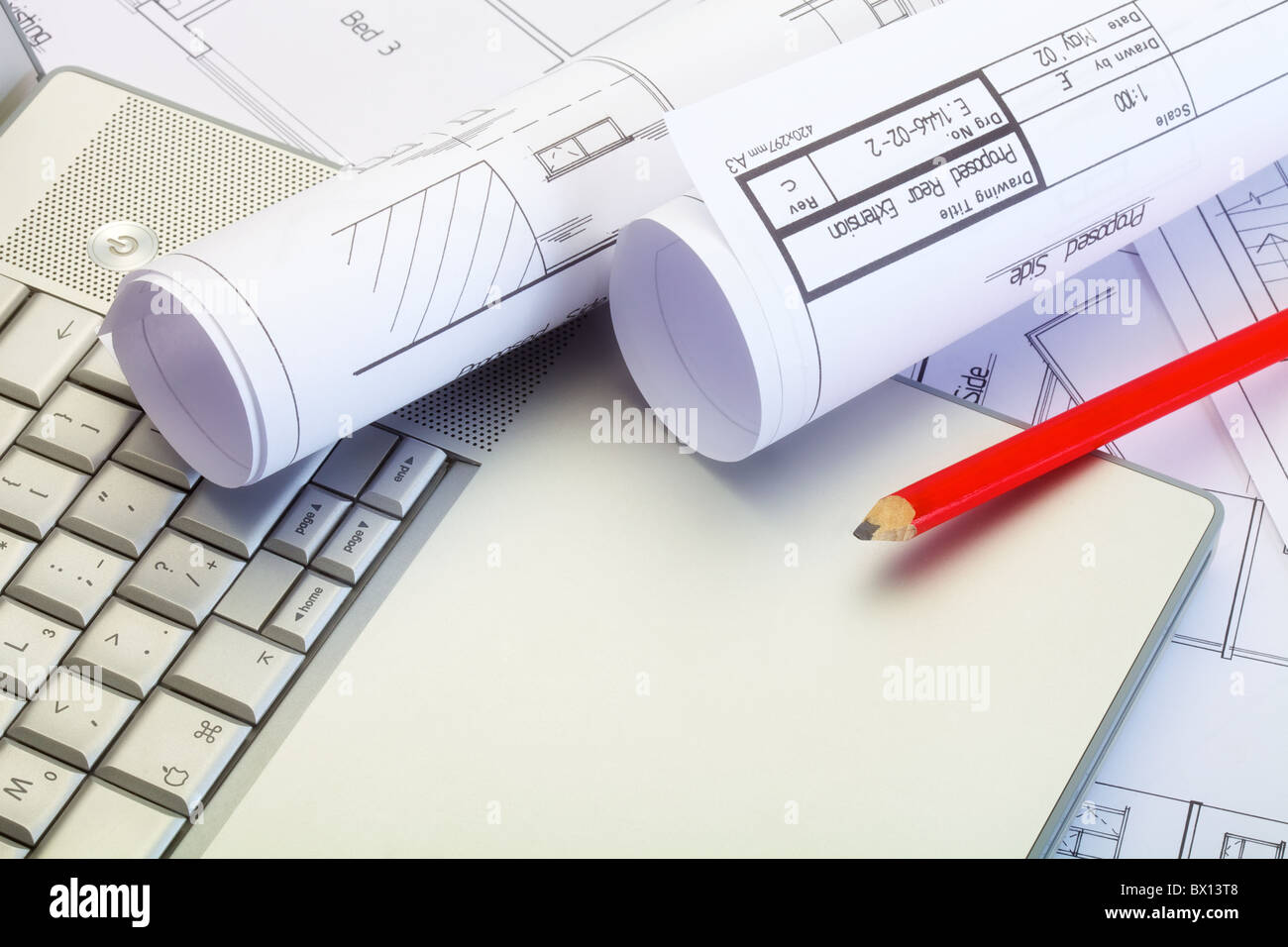 Close up image of house plans and a laptop computer Stock Photo - Alamy