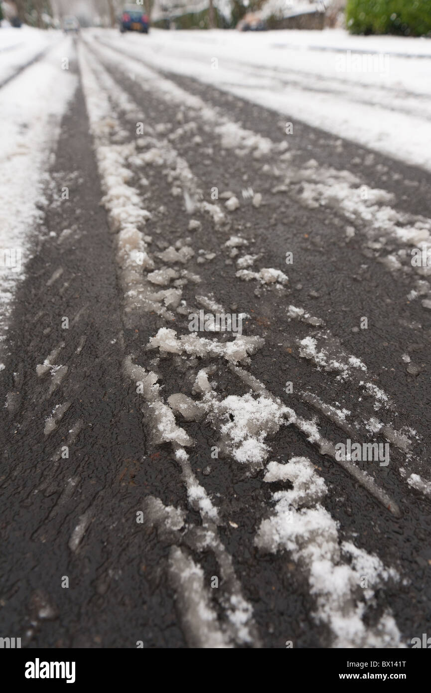 Potholes and melting snow runoff in a country road caused by snow and ...