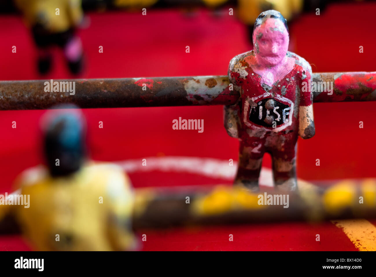 Table football player in red shirt, with peeled surface Stock Photo - Alamy