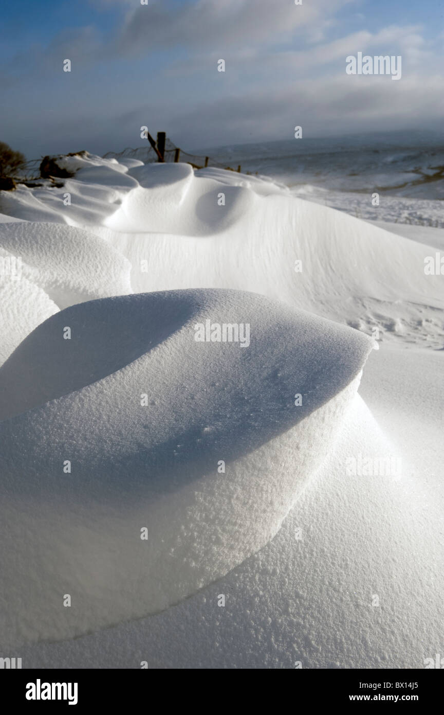 Snow drifts forming at the back of a stone wall Stock Photo - Alamy