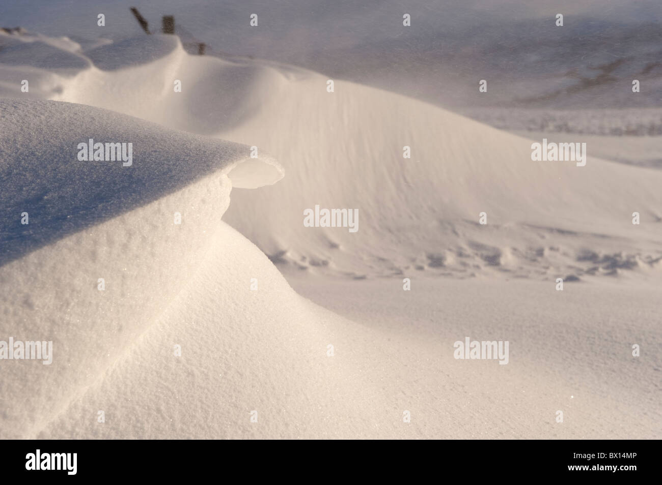 Snow drifts forming at the back of a stone wall Stock Photo - Alamy