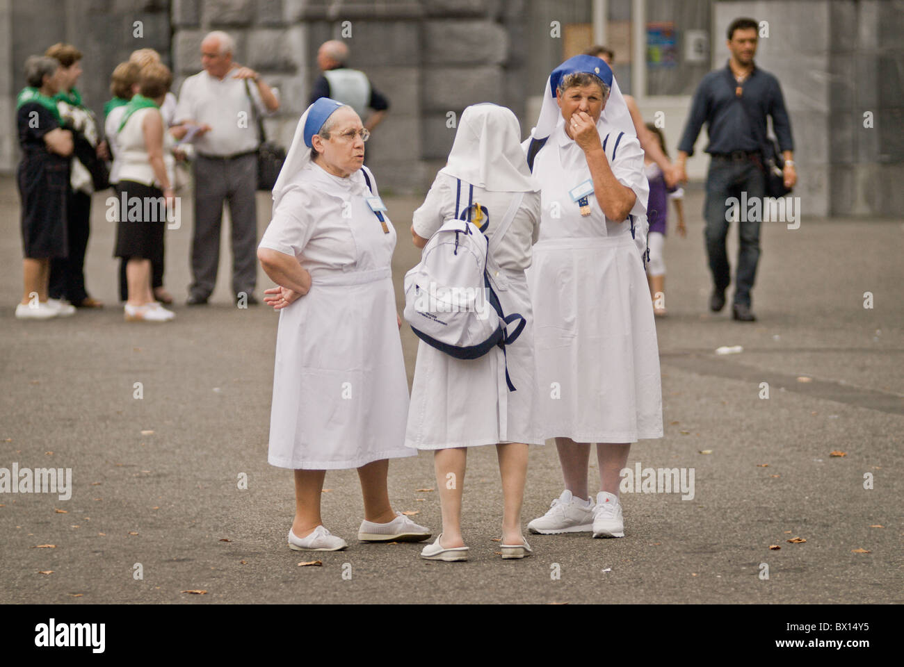 volunteer helpers at Lourdes near the grotto of Bernadette, South of ...