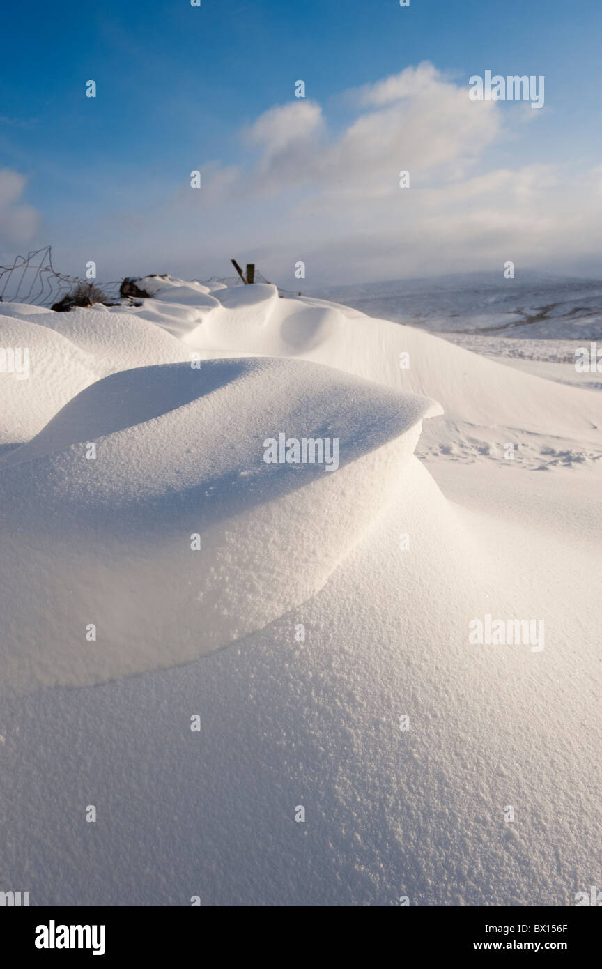 Snow drifts forming at the back of a stone wall Stock Photo - Alamy