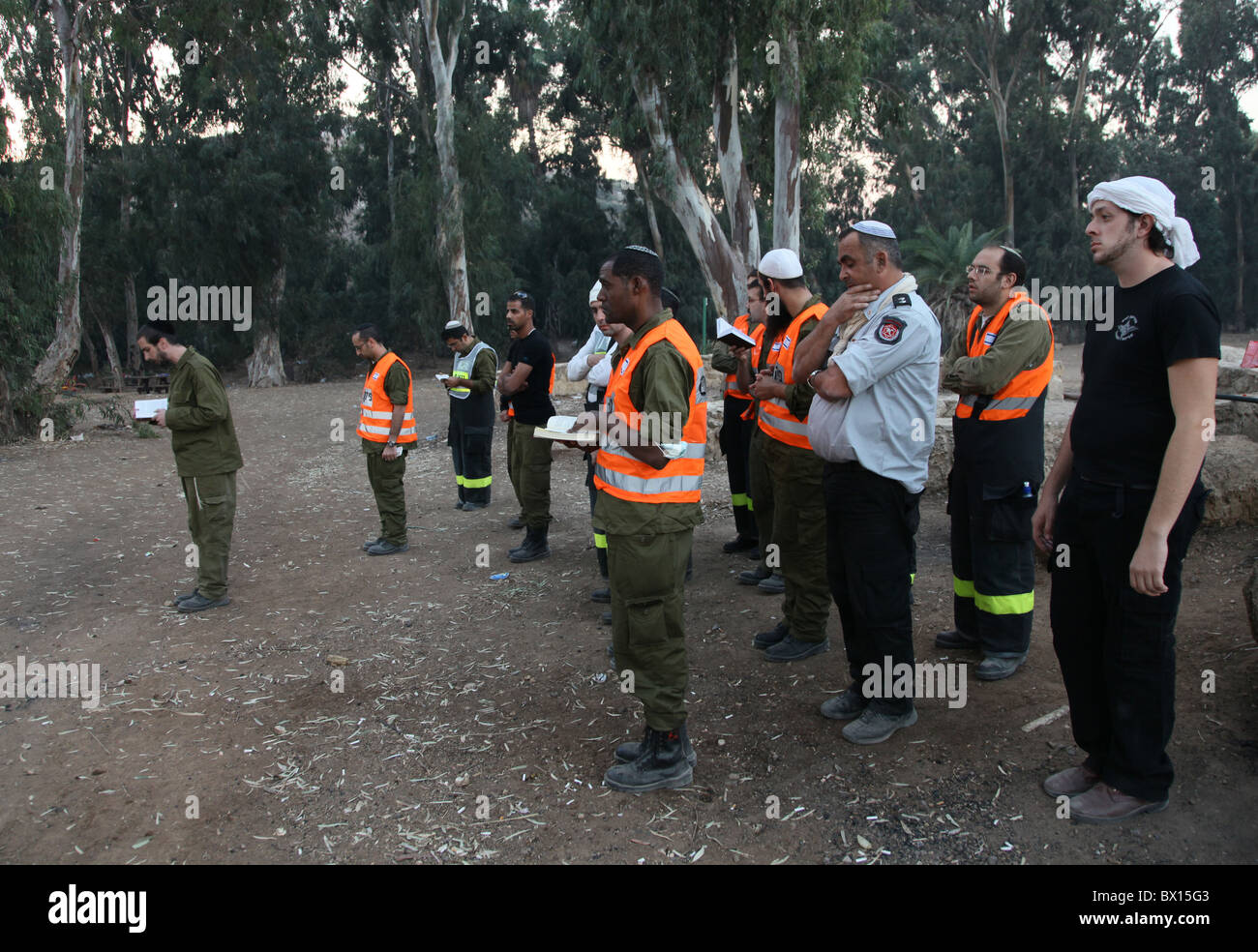 Firefighters and rescue soldiers praying during the Carmel Range forest ...