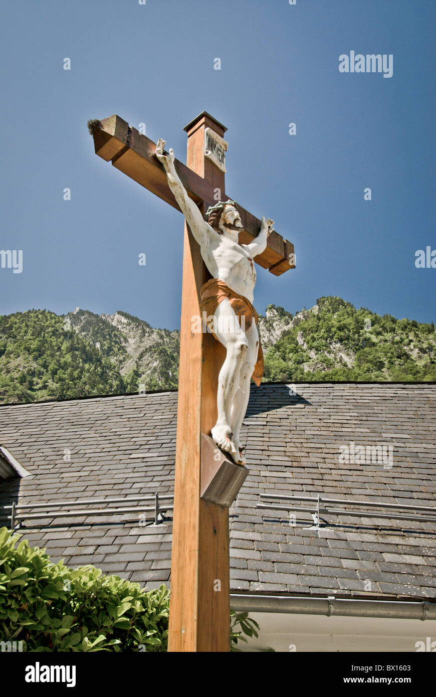 Crucifix with Christ in mountain village Stock Photo - Alamy