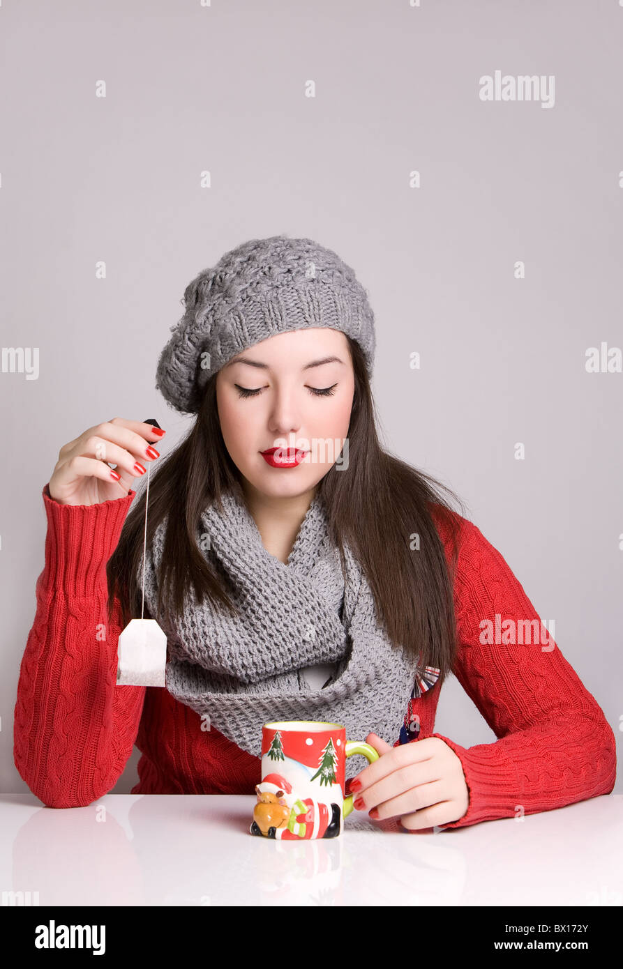 Young woman with hat prepares tea Stock Photo - Alamy