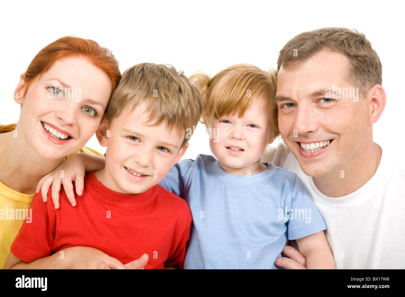 Portrait of cheerful parents with their two children on a white ...