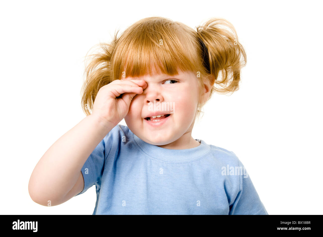 Portrait of small girl wiping tears on a white background Stock Photo ...