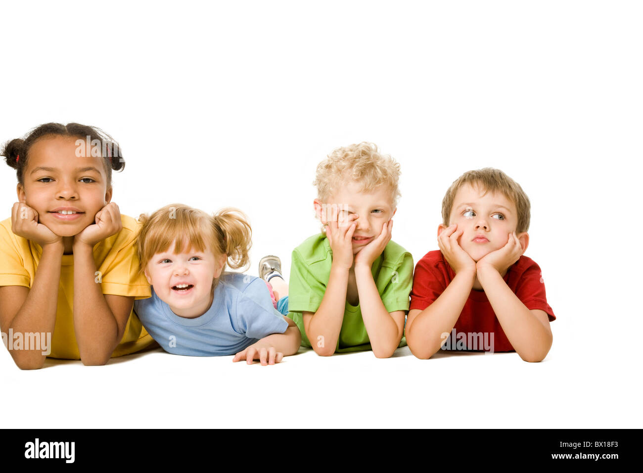 Portrait of four children lying in a line and having fun Stock Photo ...