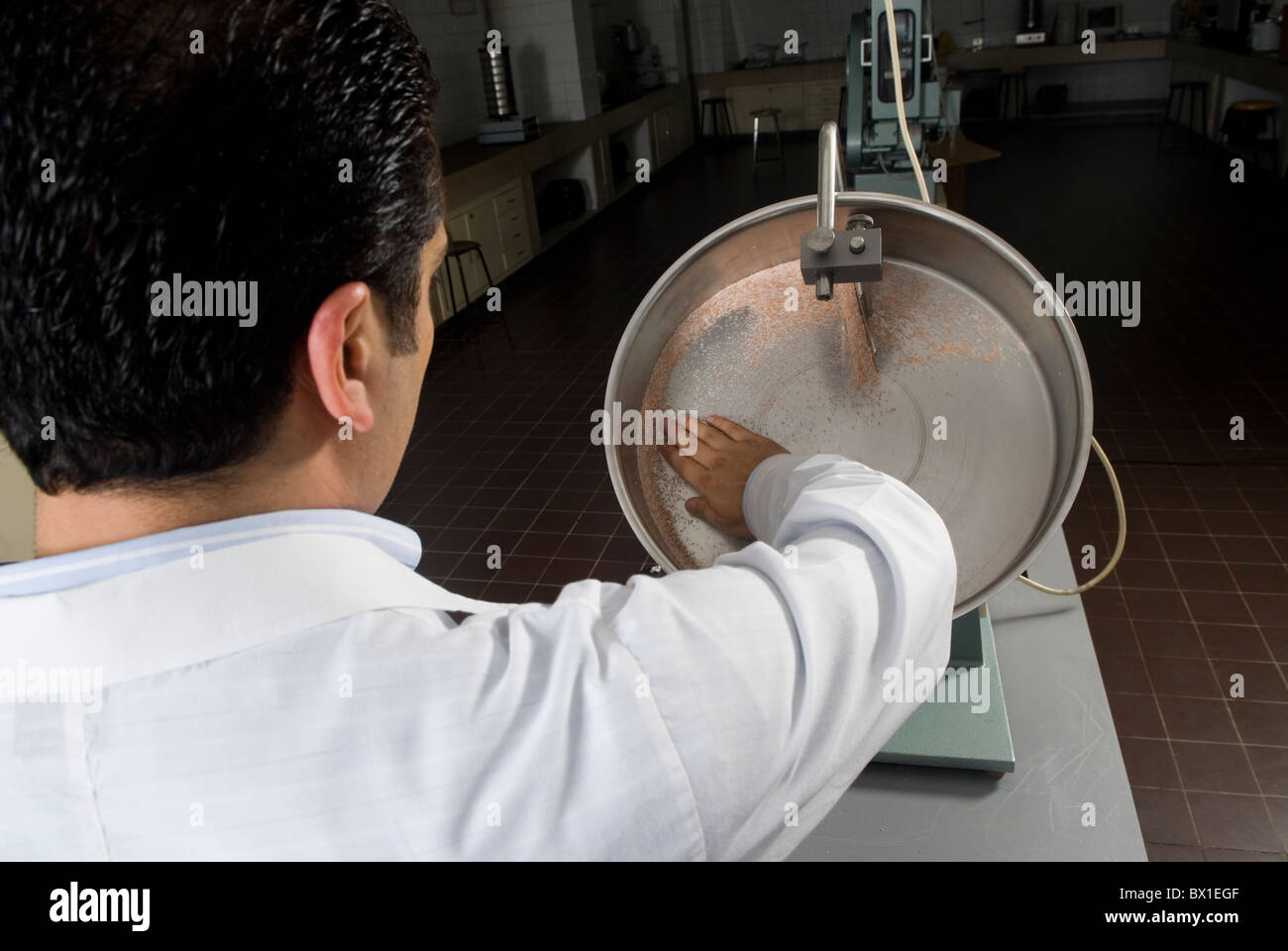 lab technician working on medicine mixing machine inside the laboratory ...